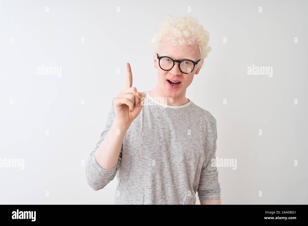 Young albino blond man wearing striped t-shirt and glasses over ...