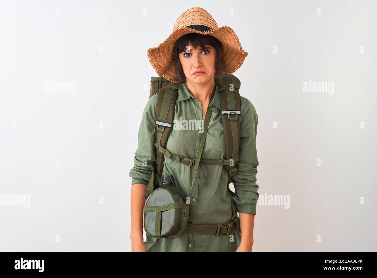 Hiker woman wearing backpack hat and water canteen over isolated white ...