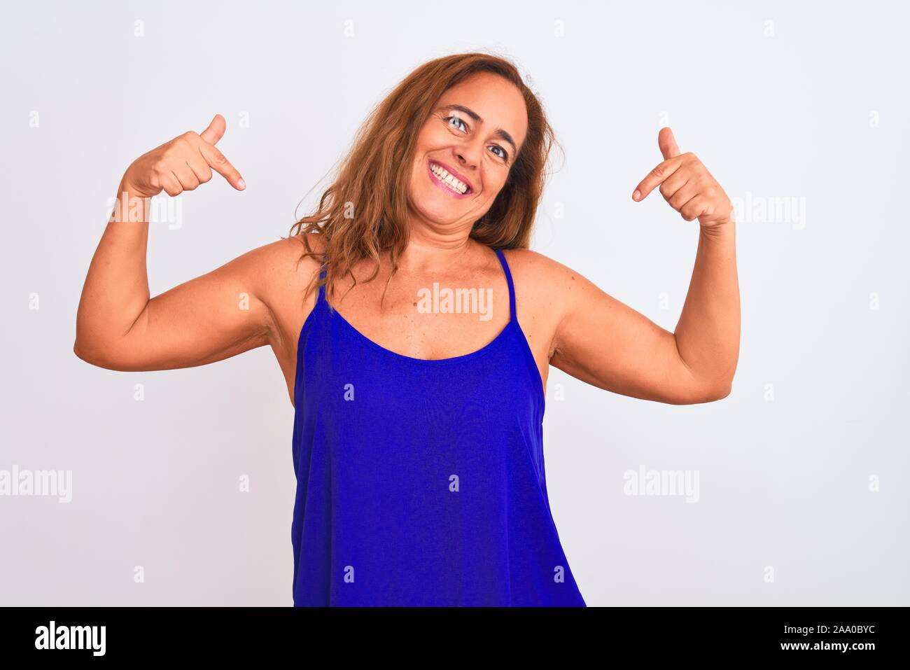 Middle age mature woman standing over white isolated background looking ...