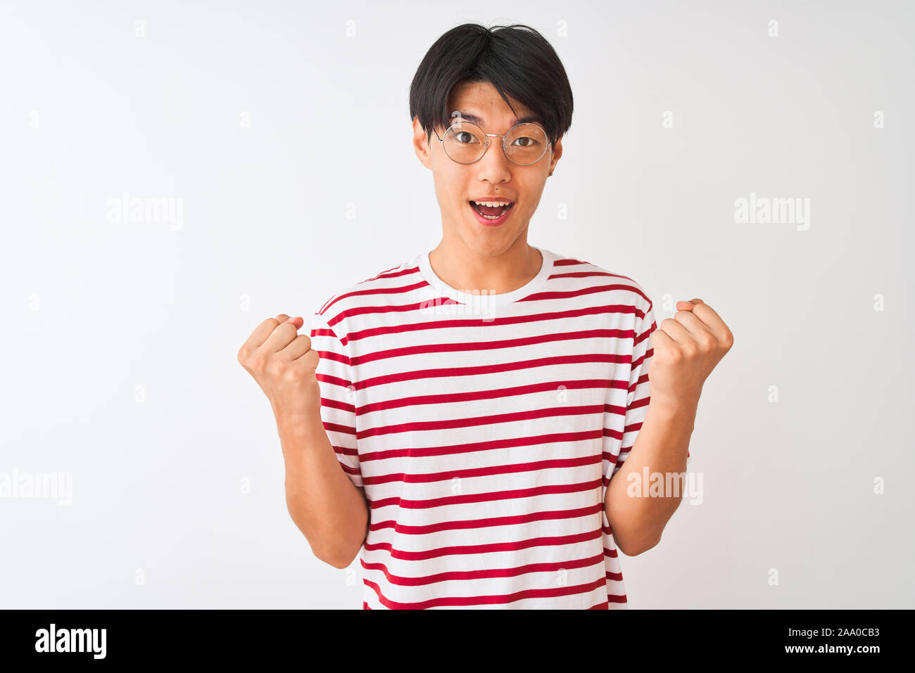 Young chinese man wearing glasses and striped t-shirt standing over ...