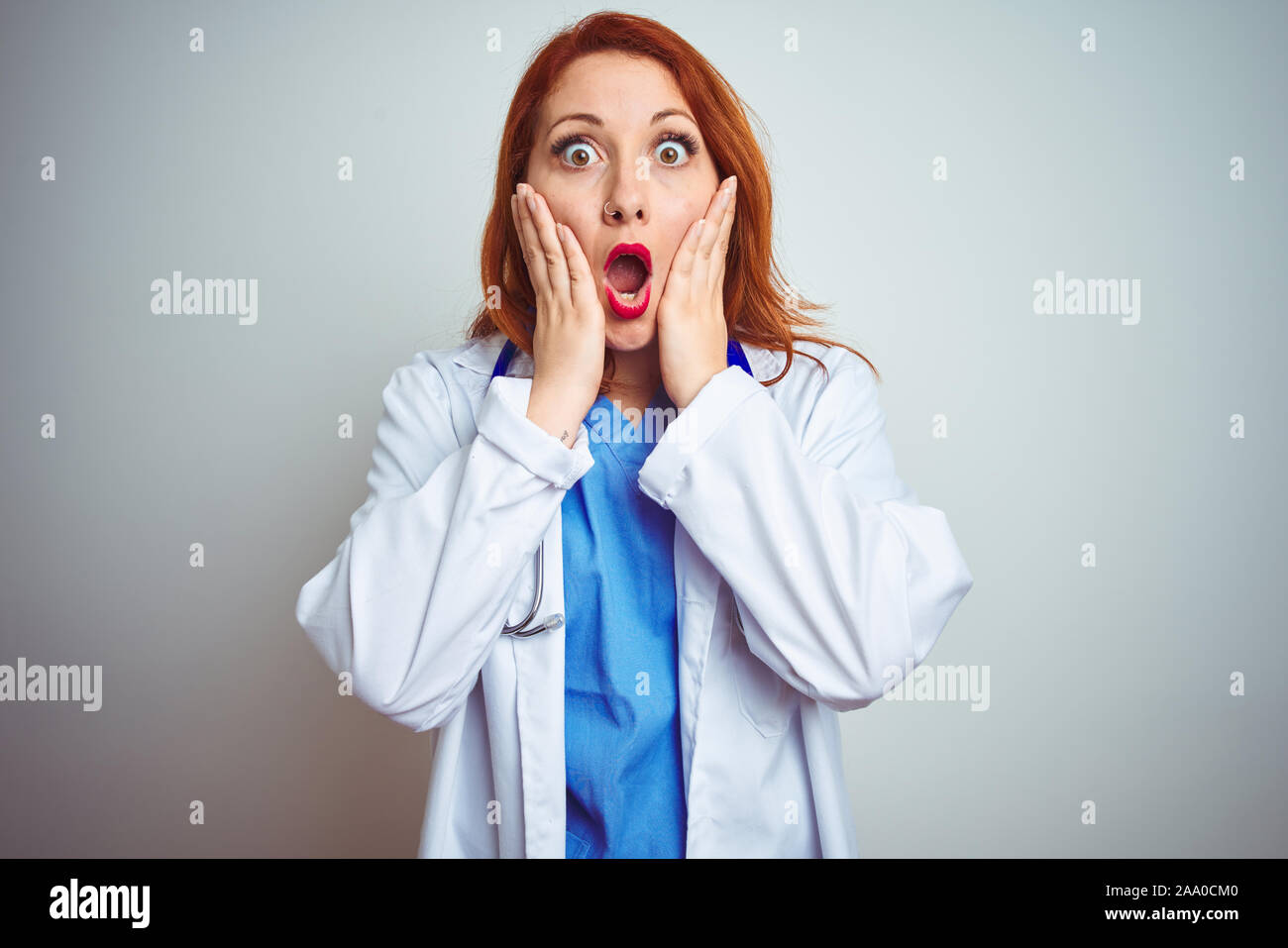 Young redhead doctor woman using stethoscope over white isolated ...