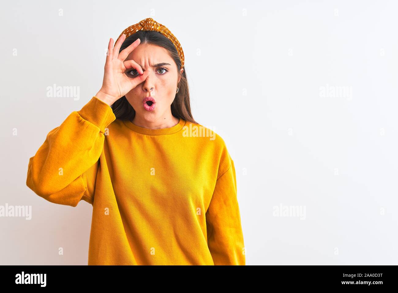 Young beautiful woman wearing yellow sweater and diadem over isolated ...