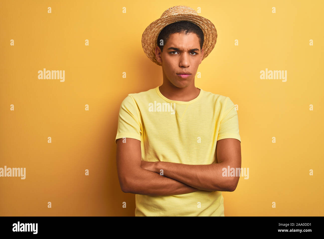 Young handsome arab man wearing t-shirt and summer hat over isolated ...
