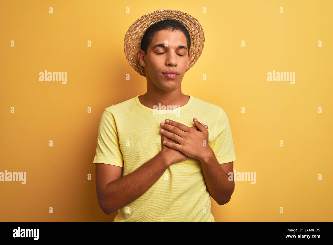 Young handsome arab man wearing t-shirt and summer hat over isolated ...