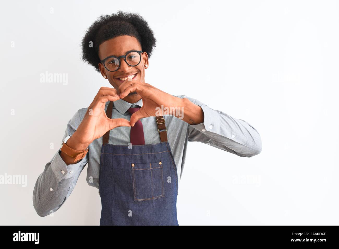Young african american shopkeeper man wearing apron glasses over ...