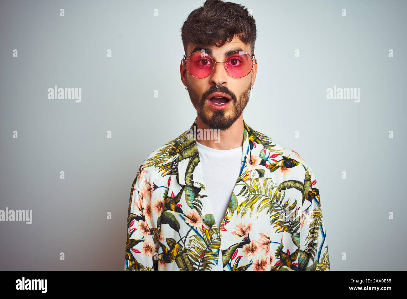 Man with tattoo on vacation wearing summer shirt sunglasses over ...