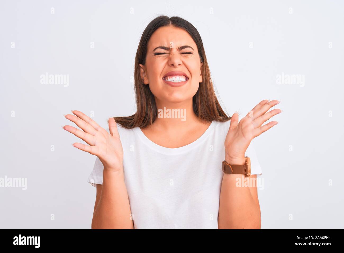 Portrait of beautiful and young brunette woman standing over isolated ...