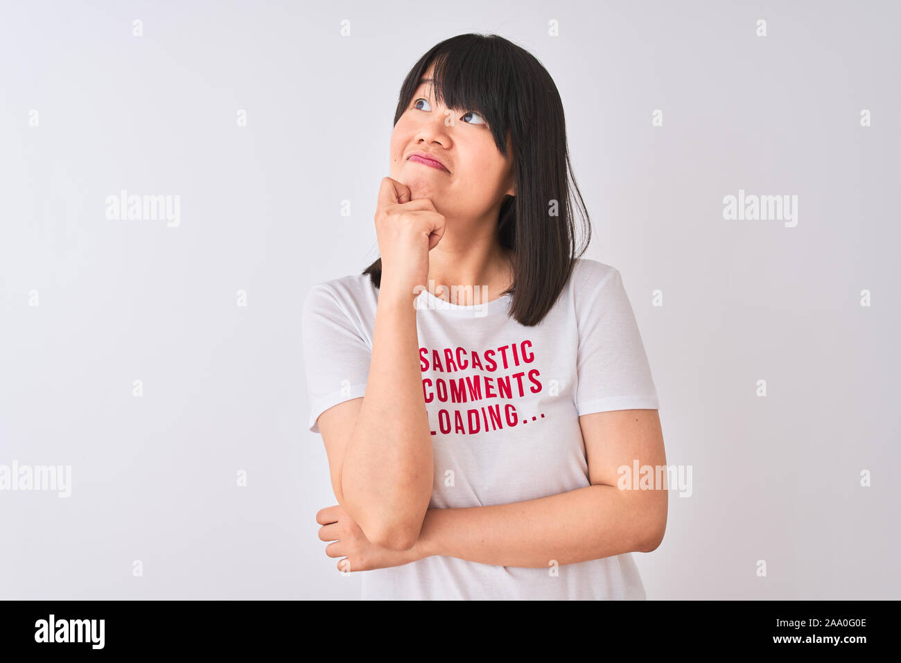Young beautiful Chinese woman wearing fanny t-shirt over isolated white ...