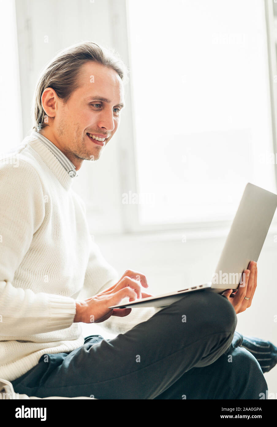 Young man looking at his portable computer. Bright light in the ...