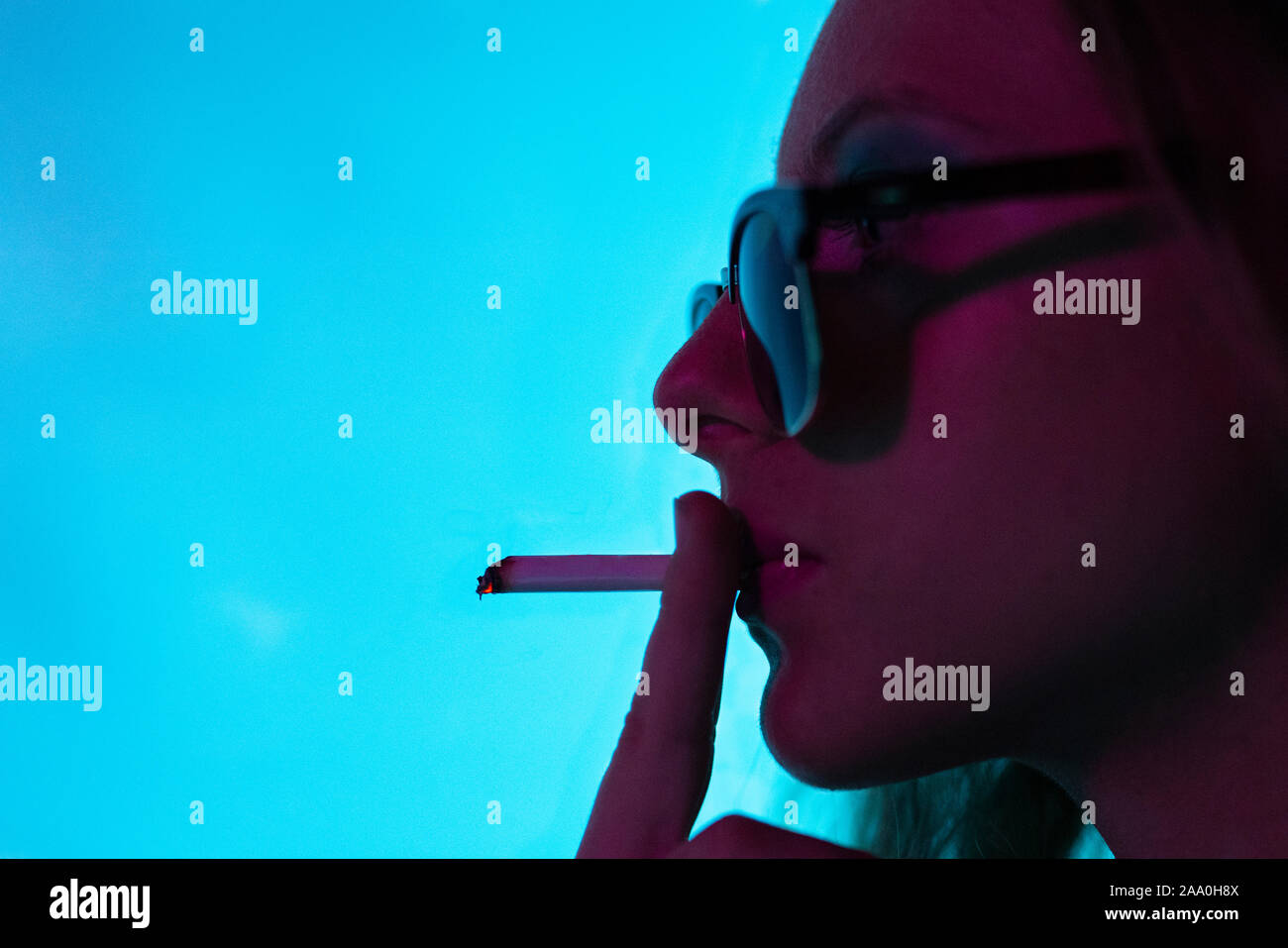 portrait girl with neon lights smoking Stock Photo - Alamy