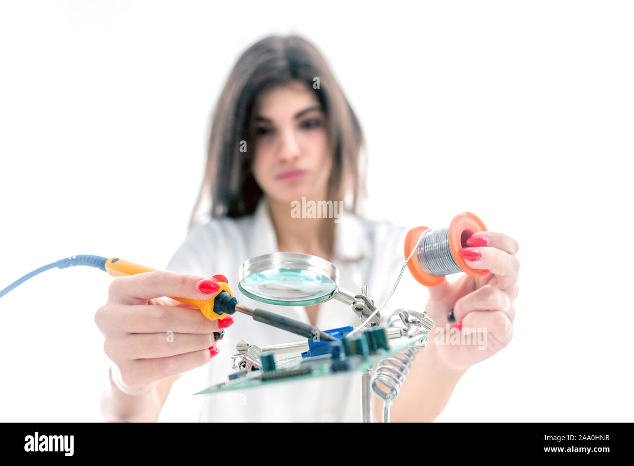 Woman using soldering iron hi-res stock photography and images - Alamy