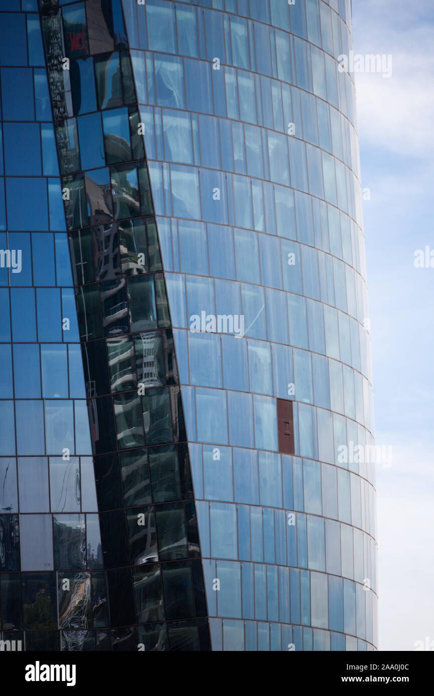 Curved blue glass exterior of a modern high rise building in Barangaroo ...