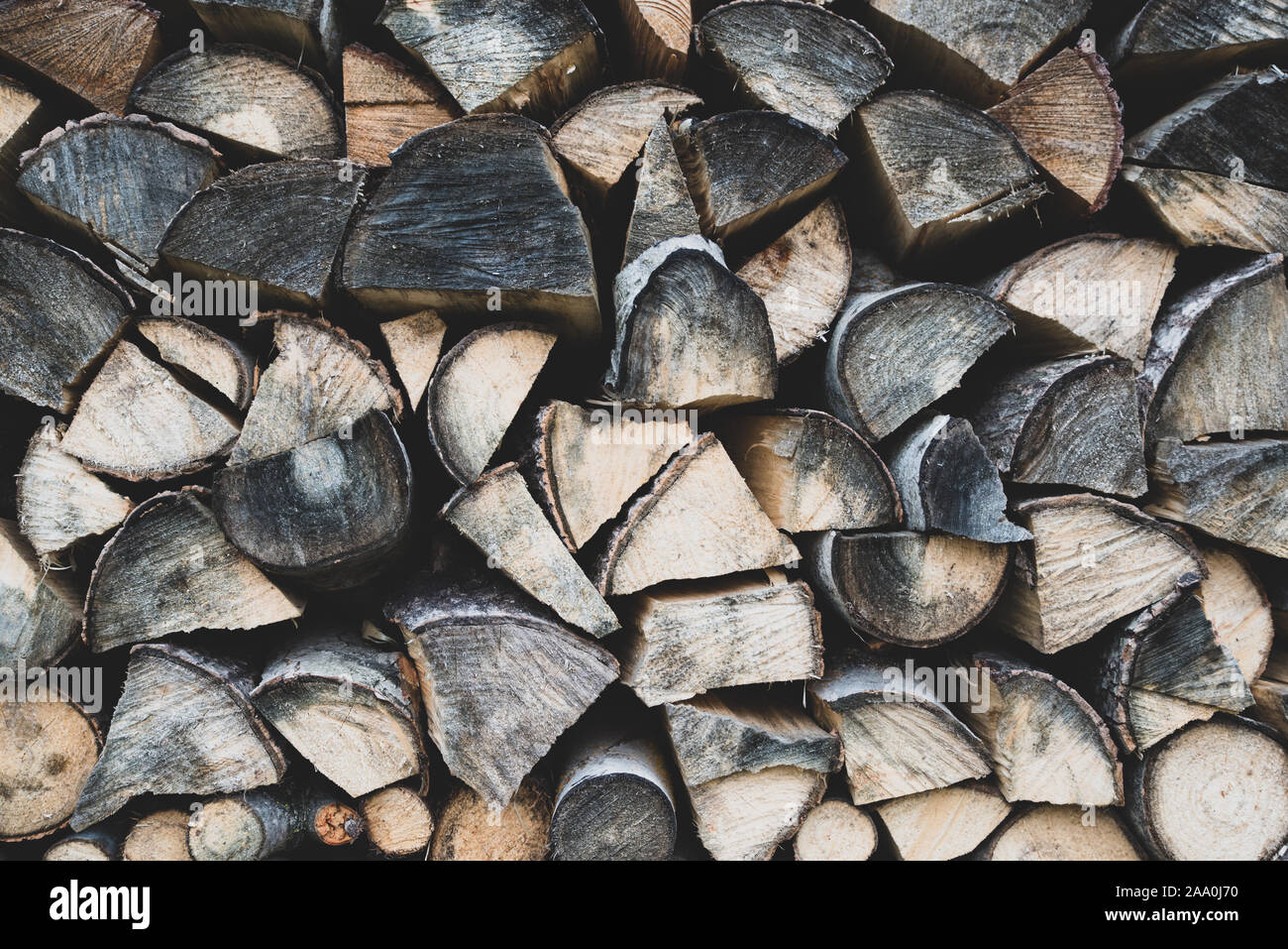 Firewood stacked near the wall. Alternative fuel. Natural background ...