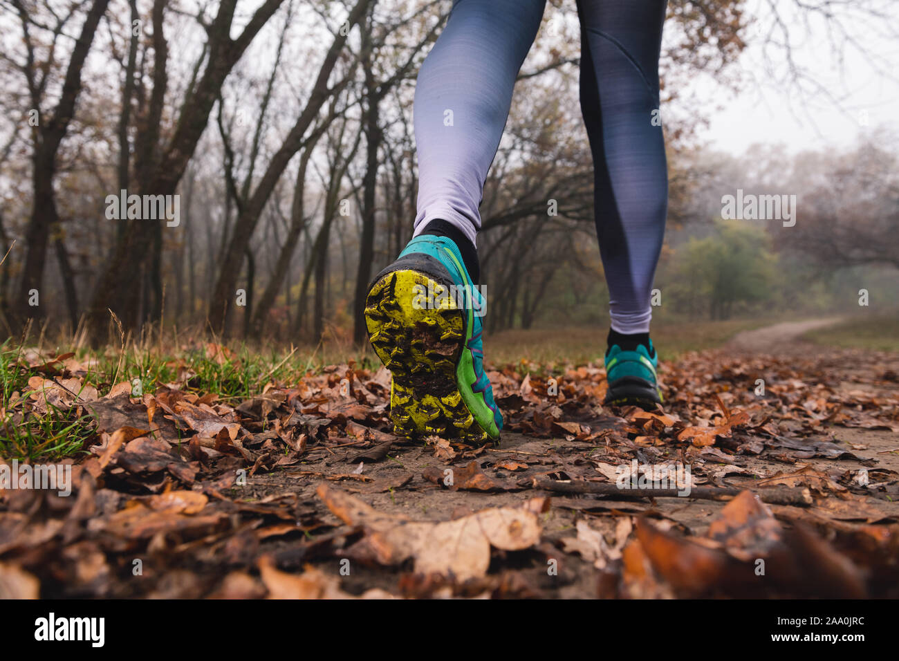 Young female jogging in blue sportswear outdoors back view. Shooting ...