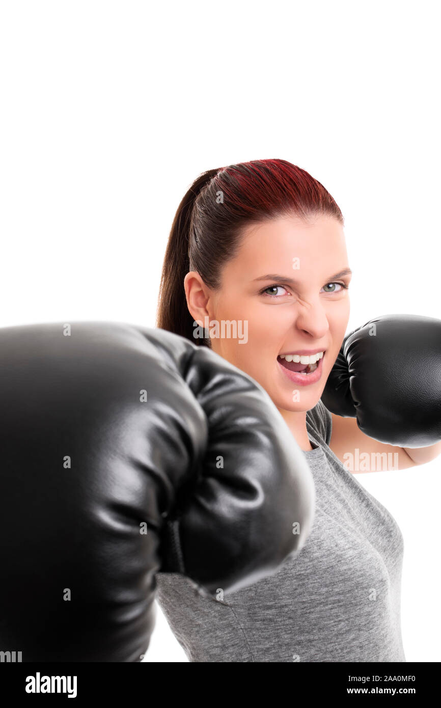 Close up shot of a young beautiful girl with boxing gloves punching the ...