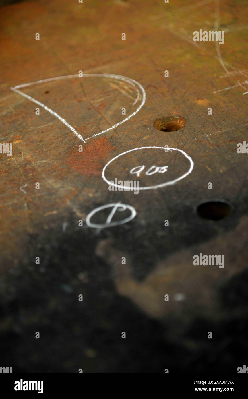 engineers chalk marks on rusting metal work bench Stock Photo - Alamy