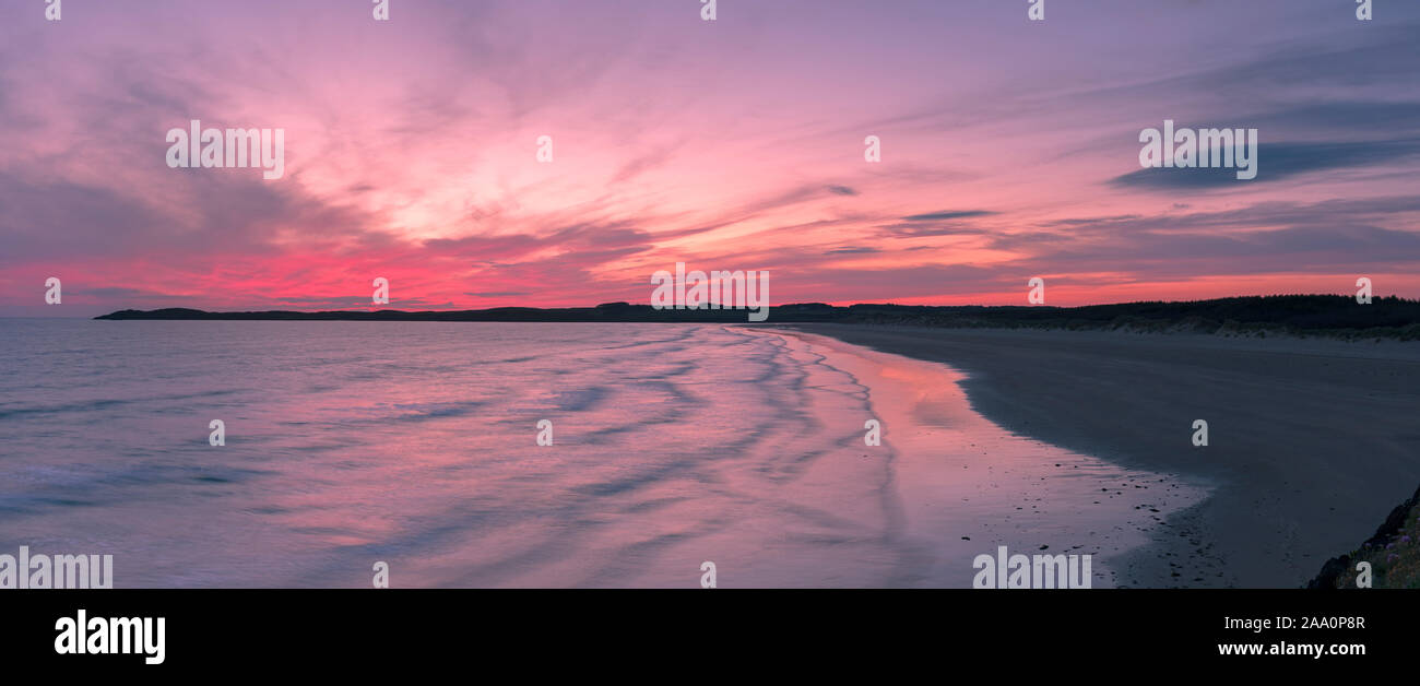 Sunset over Malltraeth Bay, Newborough Warren, Anglesey wales, UK Stock ...