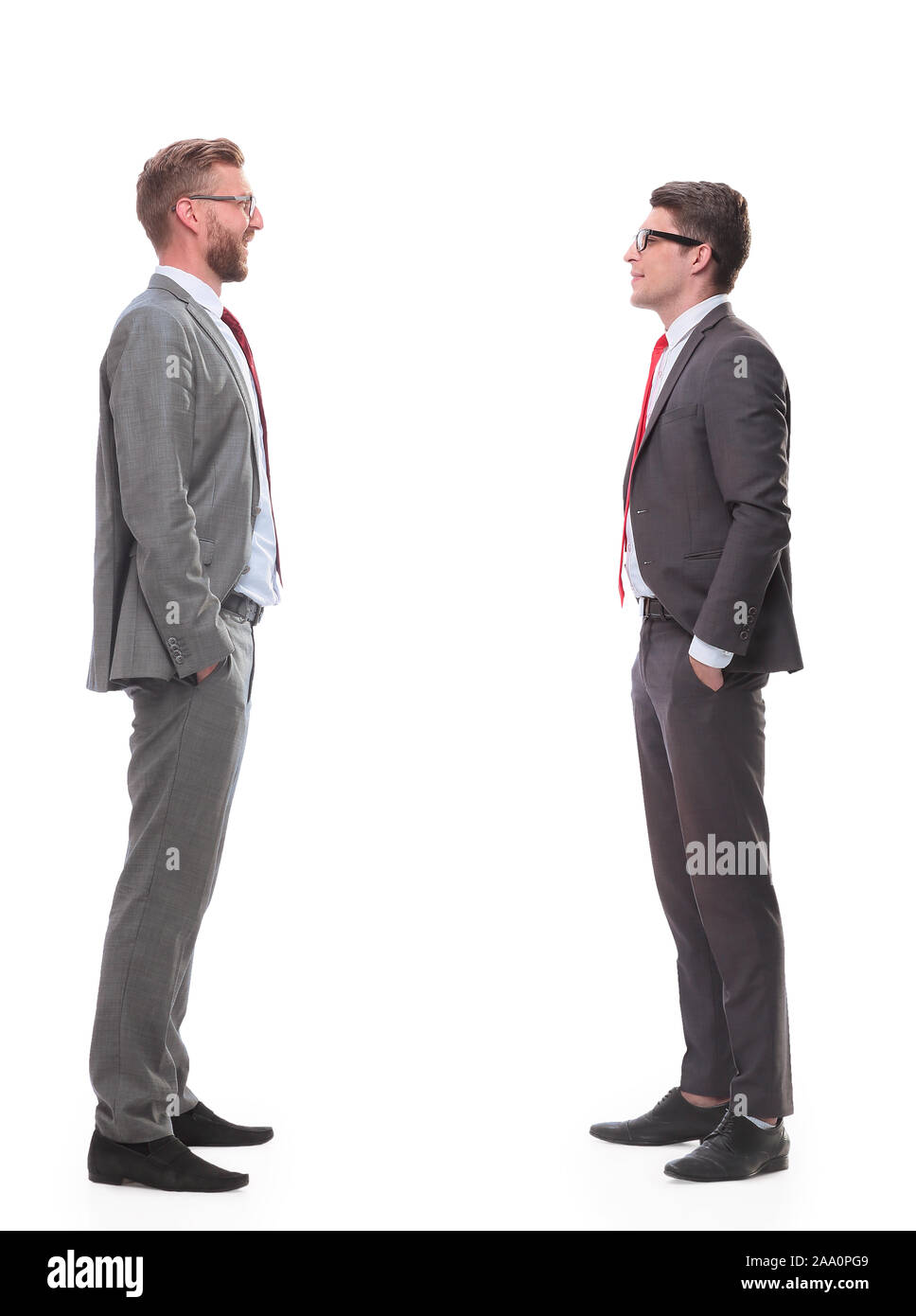 in full growth. two business men looking at each other Stock Photo - Alamy