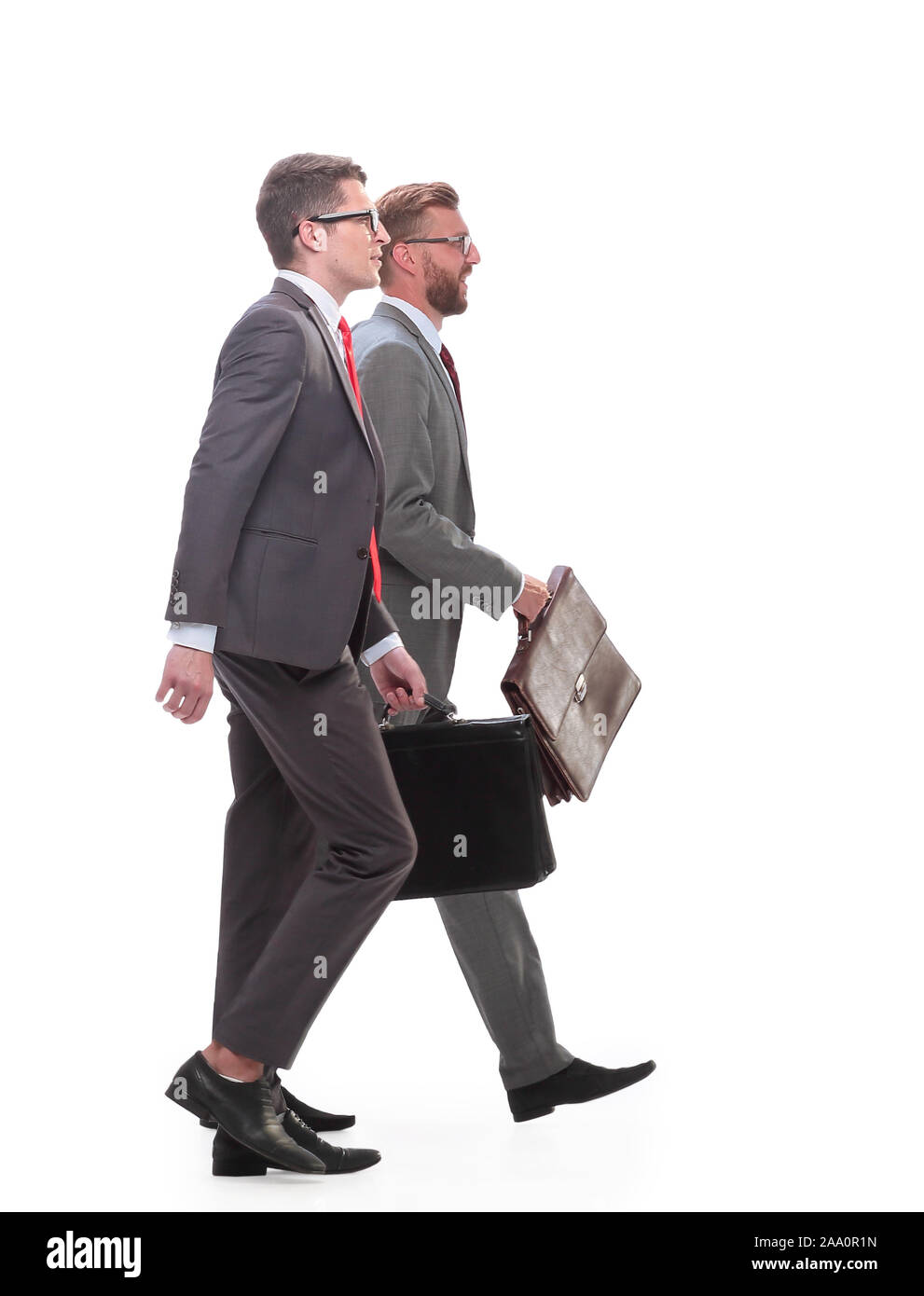 side view. two business men together striding forward Stock Photo - Alamy
