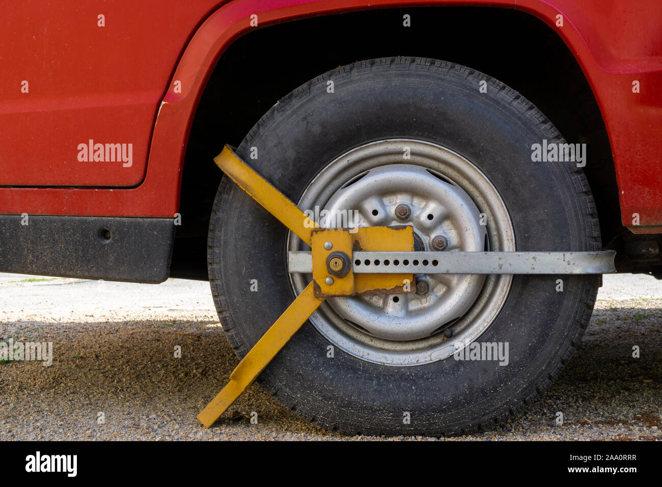 Car wheel blocked by wheel lock because illegal parking violation Stock ...