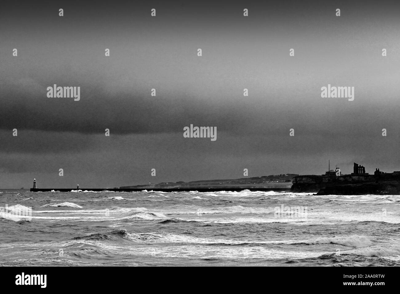 Storms and waves over Tynemouth Priory and lighthouse Stock Photo - Alamy