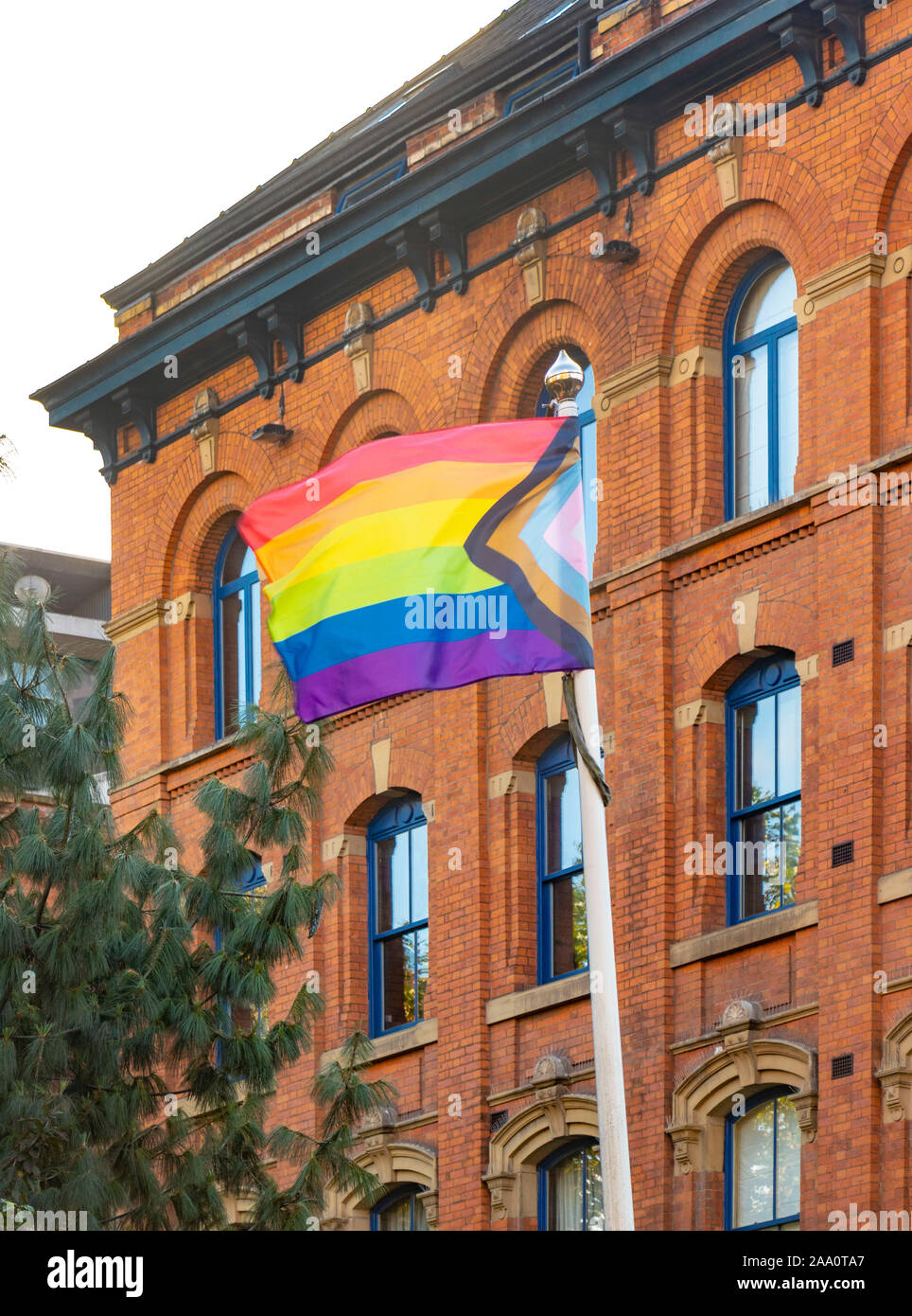 gay rainbow flag flying in Canal street in Manchester UK Stock Photo ...