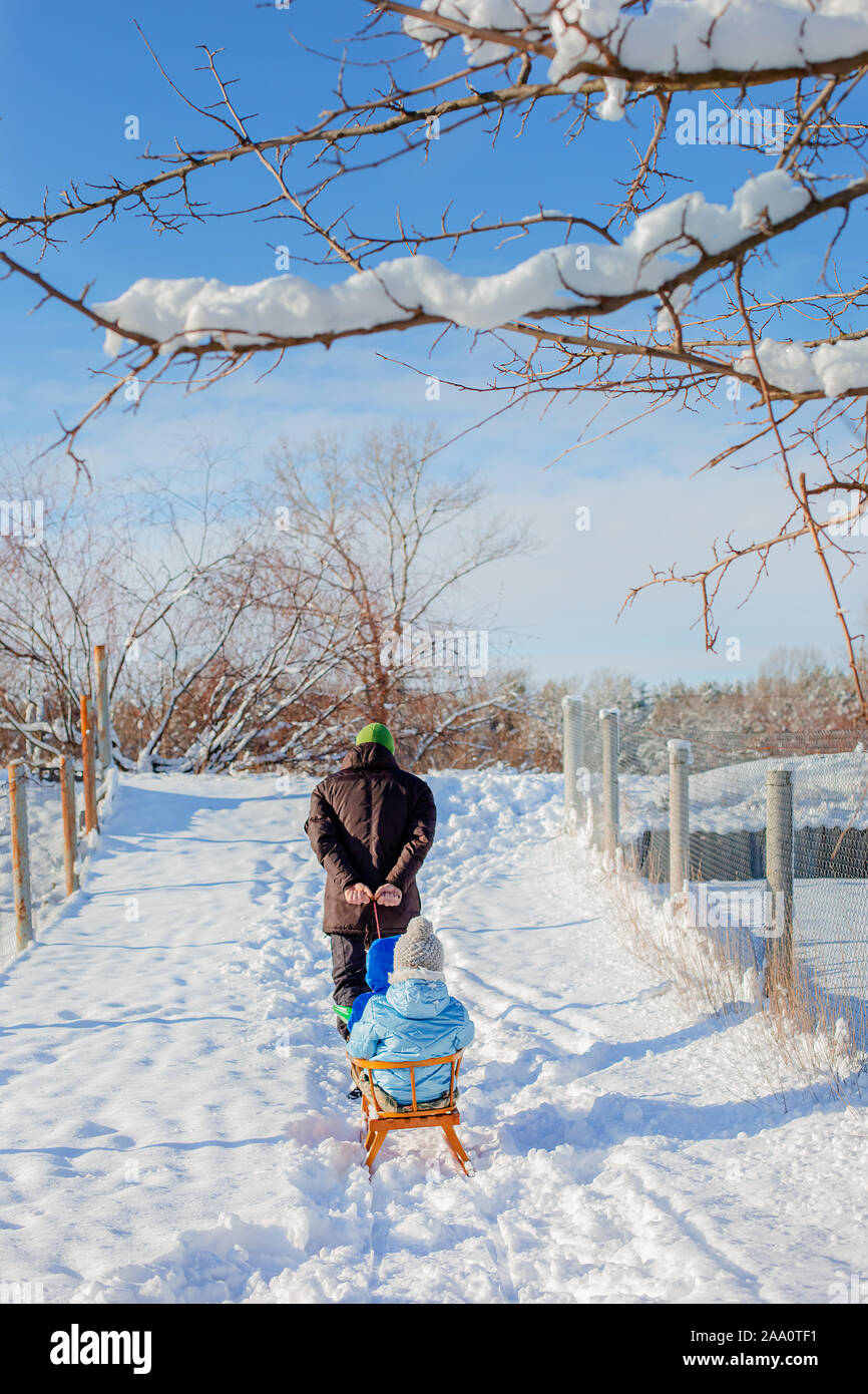 Children on sledge back view hi-res stock photography and images - Alamy