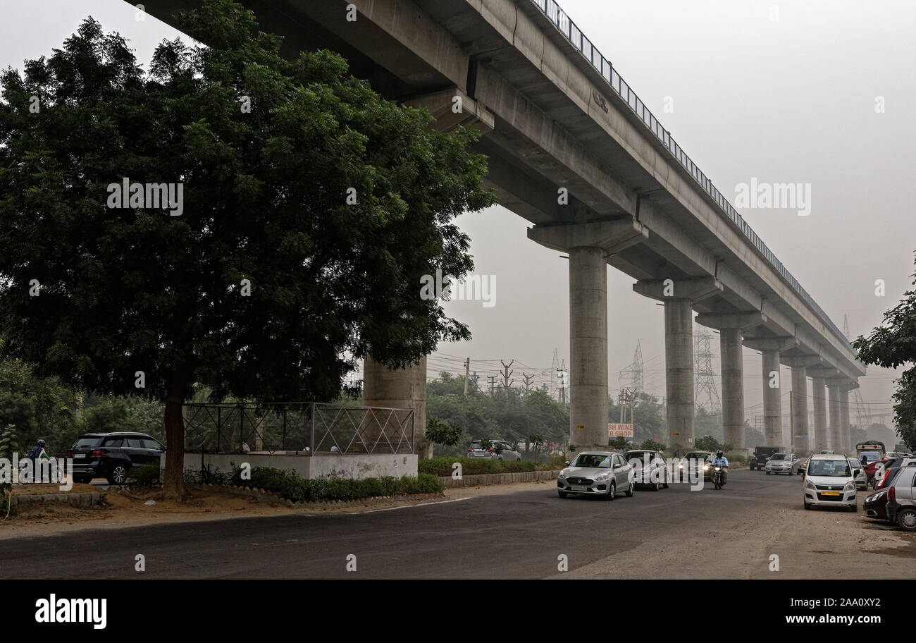 Road traffic by and below the rapid metro track at sector 55 Gurgaon ...