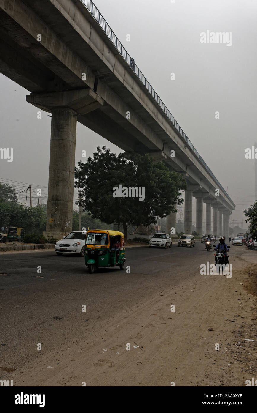 Road traffic by and below the rapid metro track at sector 55 Gurgaon ...