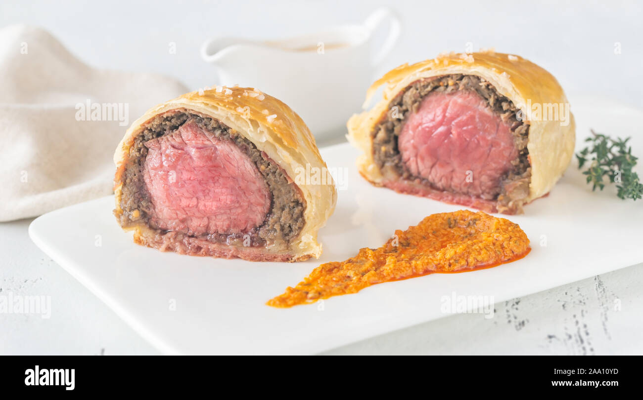Portion of beef Wellington on the white plate: cross section Stock ...