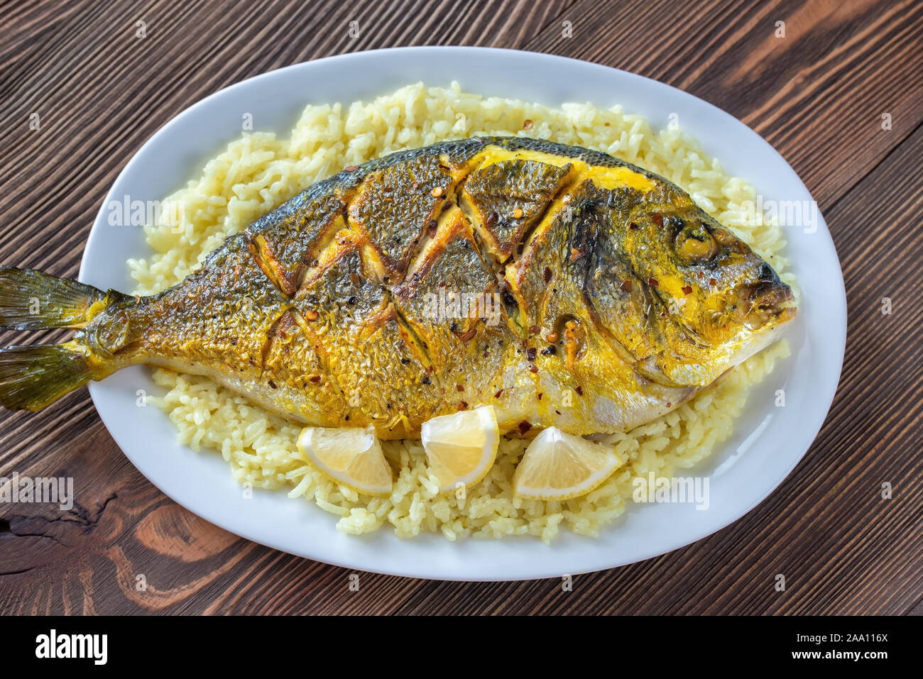 Fried saffron sea bream with curry rice Stock Photo - Alamy