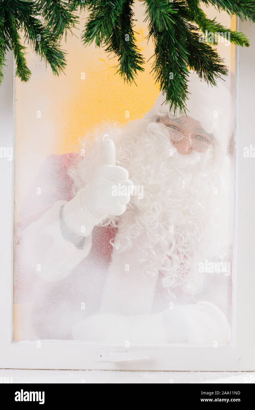 Santa is looking at us through the window and thumbs up. Merry ...