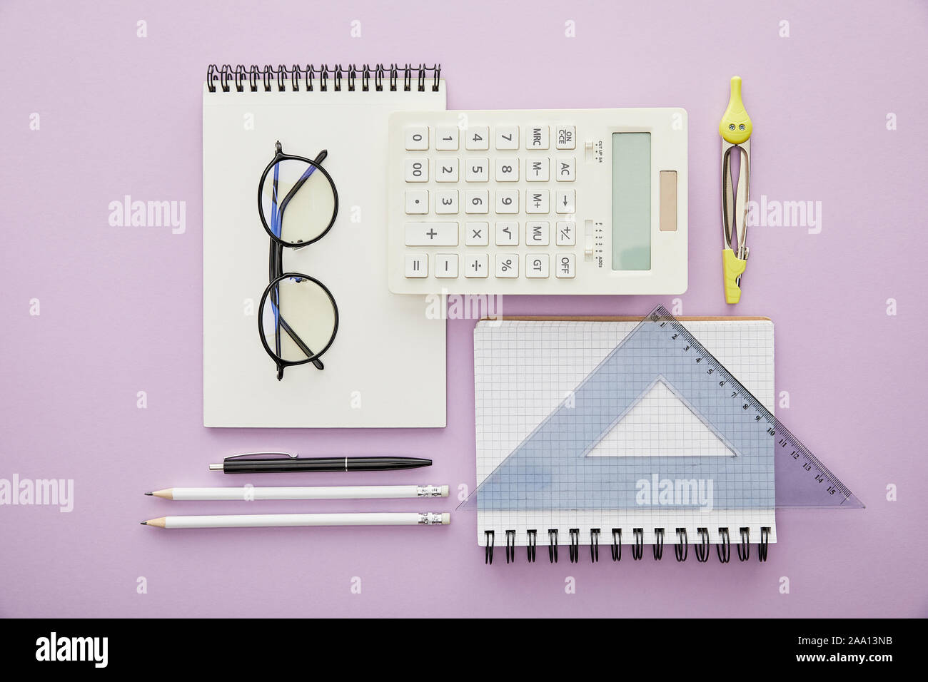flat lay with rulers and calculator near notebooks and stationery ...