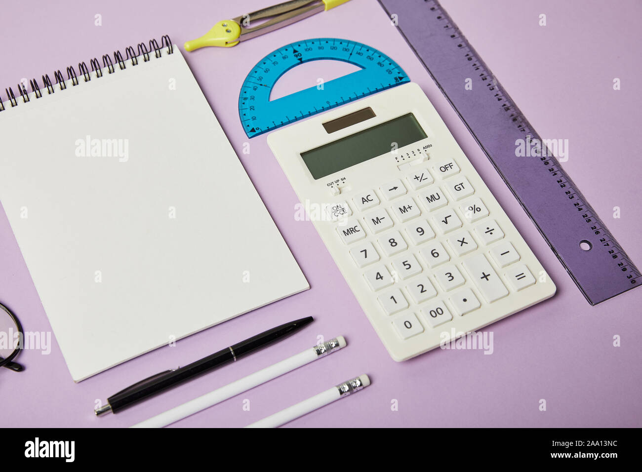 rulers and calculator near notebook and pencils with pen isolated on ...