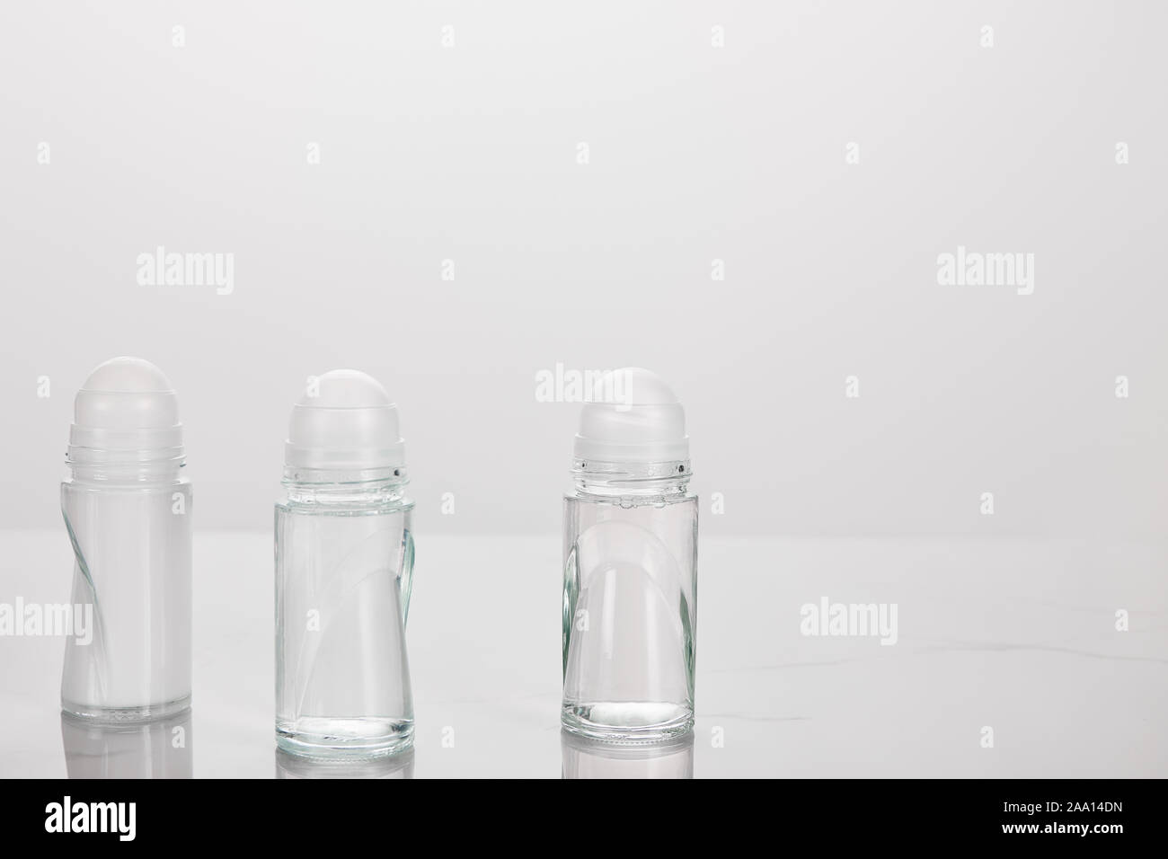 transparent bottles of deodorant isolated on white Stock Photo - Alamy