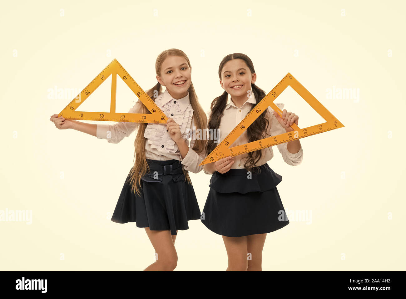 Our geometry lesson for the day. Cute schoolgirls holding triangular ...