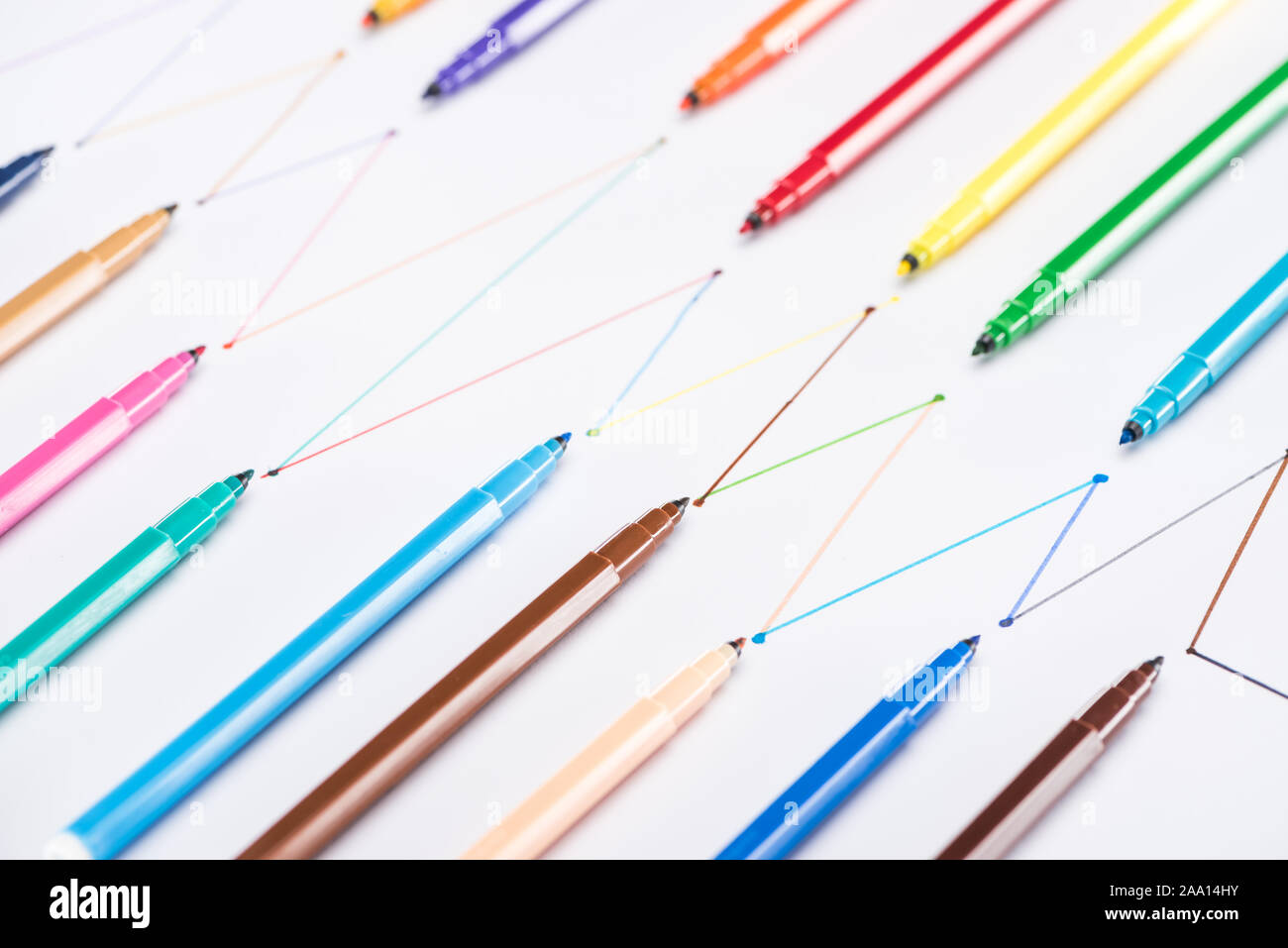 colorful felt-tip pens on white background with connected drawn lines ...