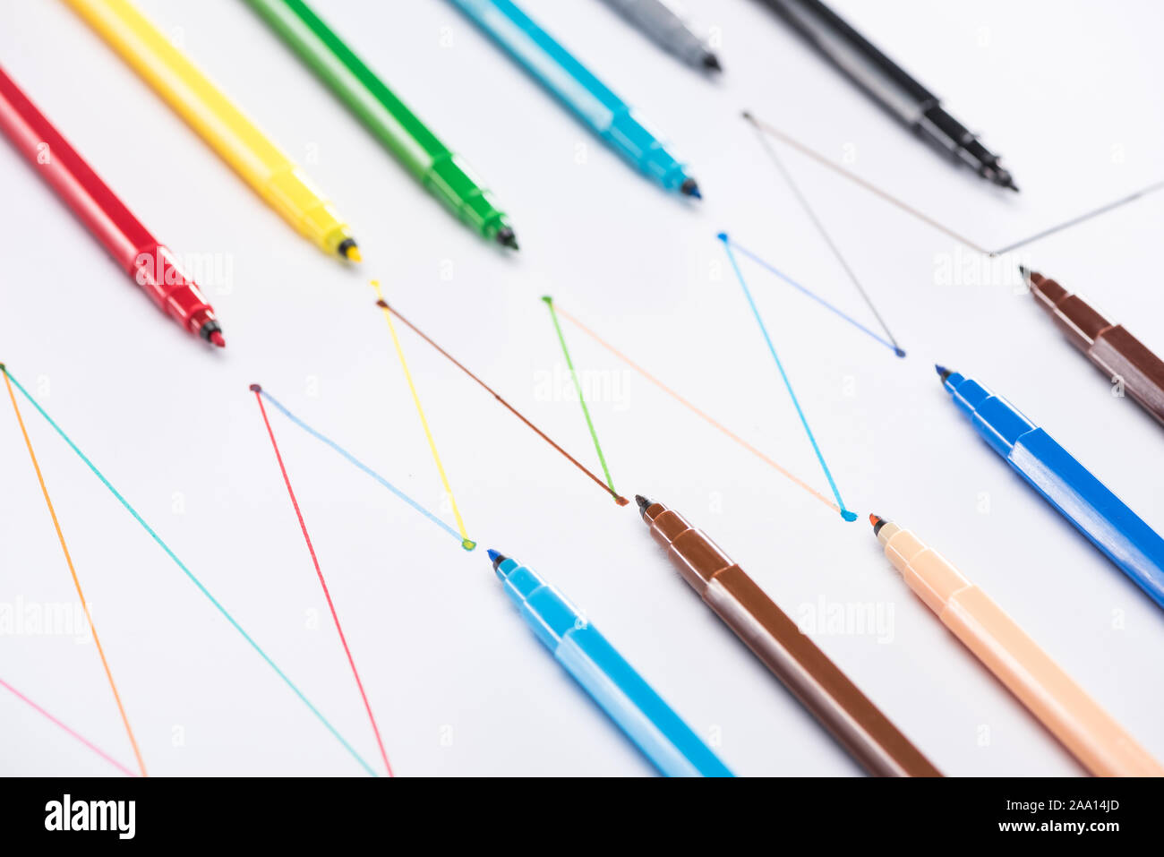 colorful felt-tip pens on white background with connected drawn lines ...