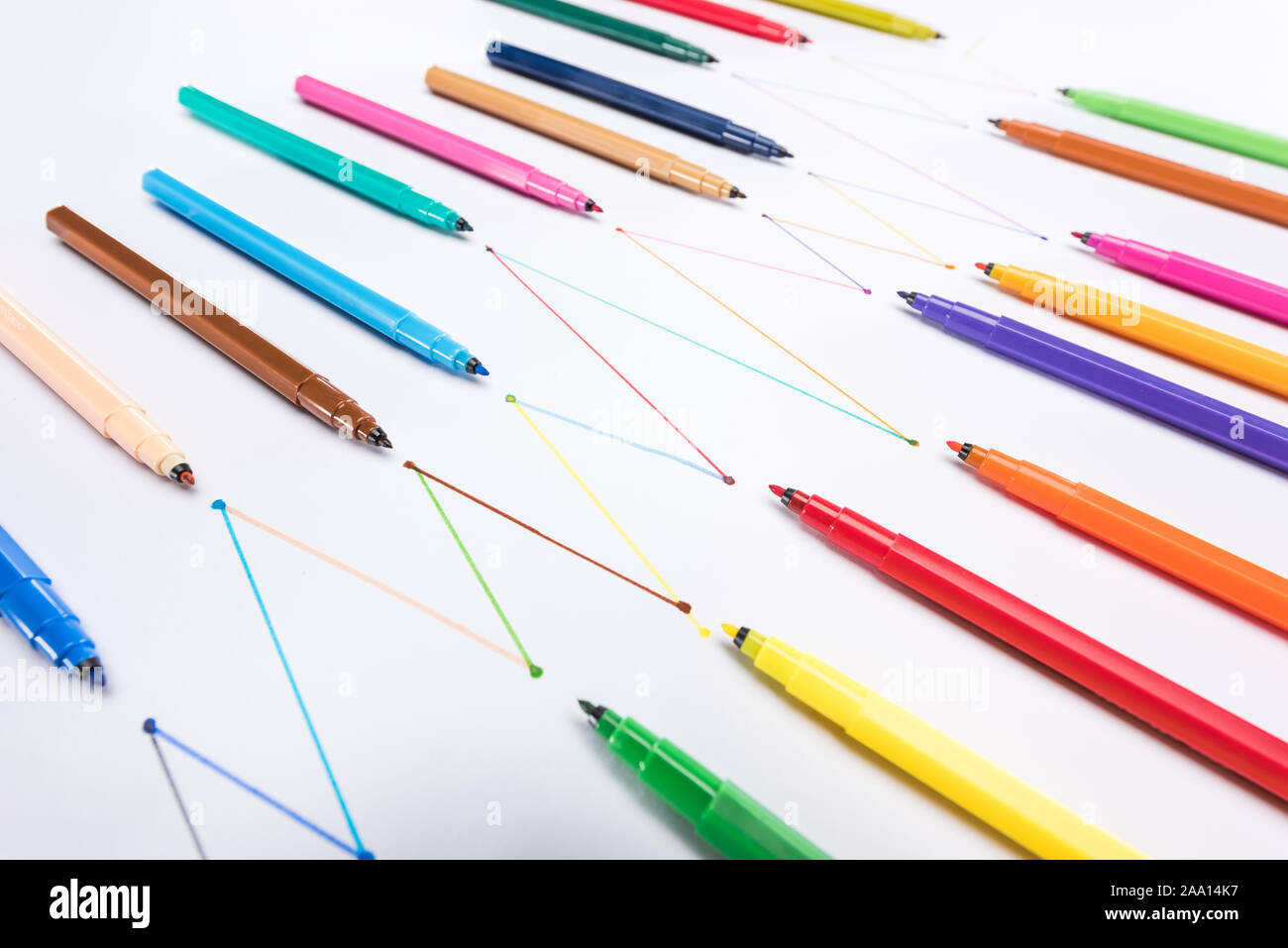 multicolored felt-tip pens on white background with connected drawn ...
