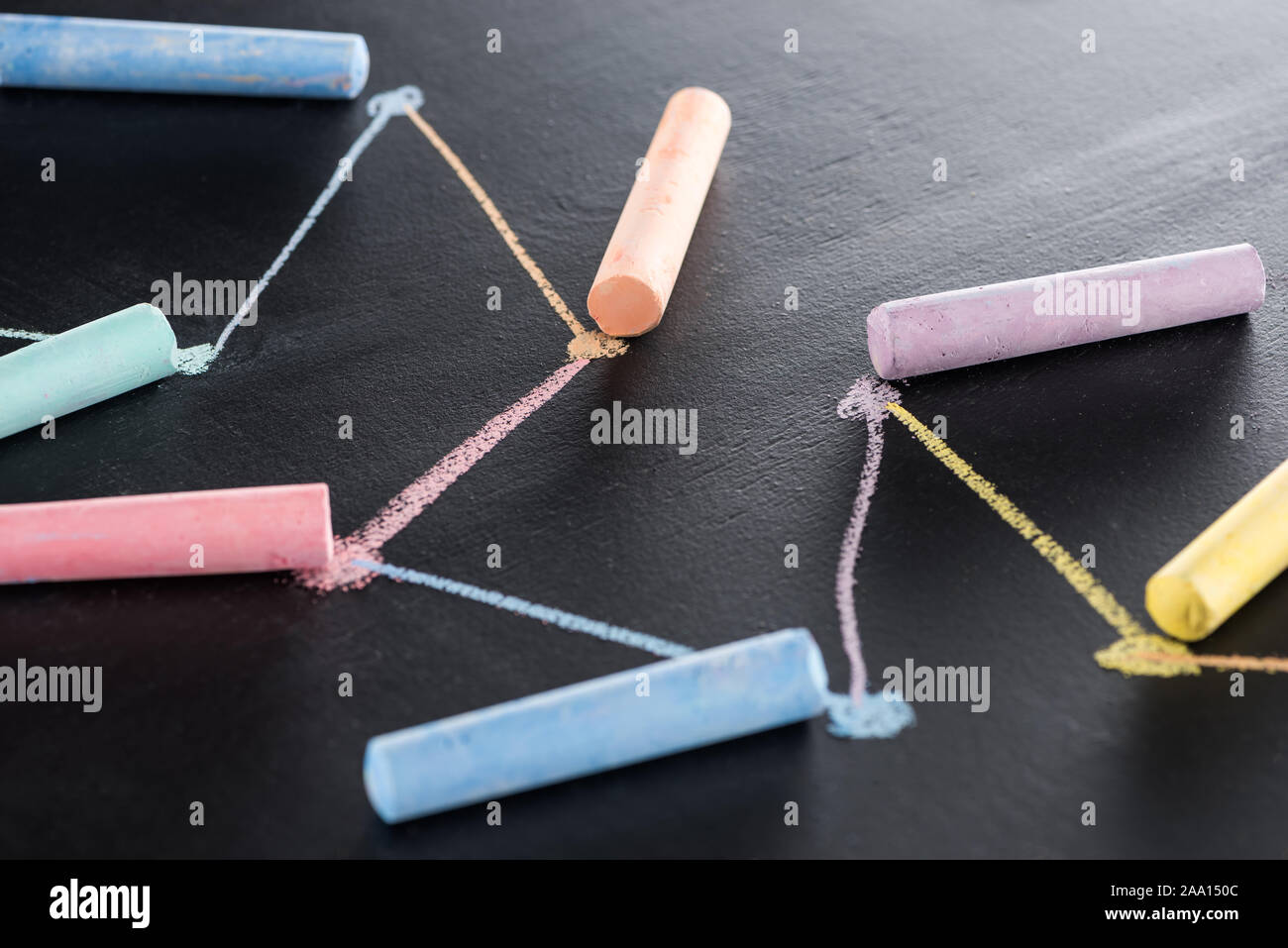 colorful chalk on black surface with connected drawn lines, connection ...