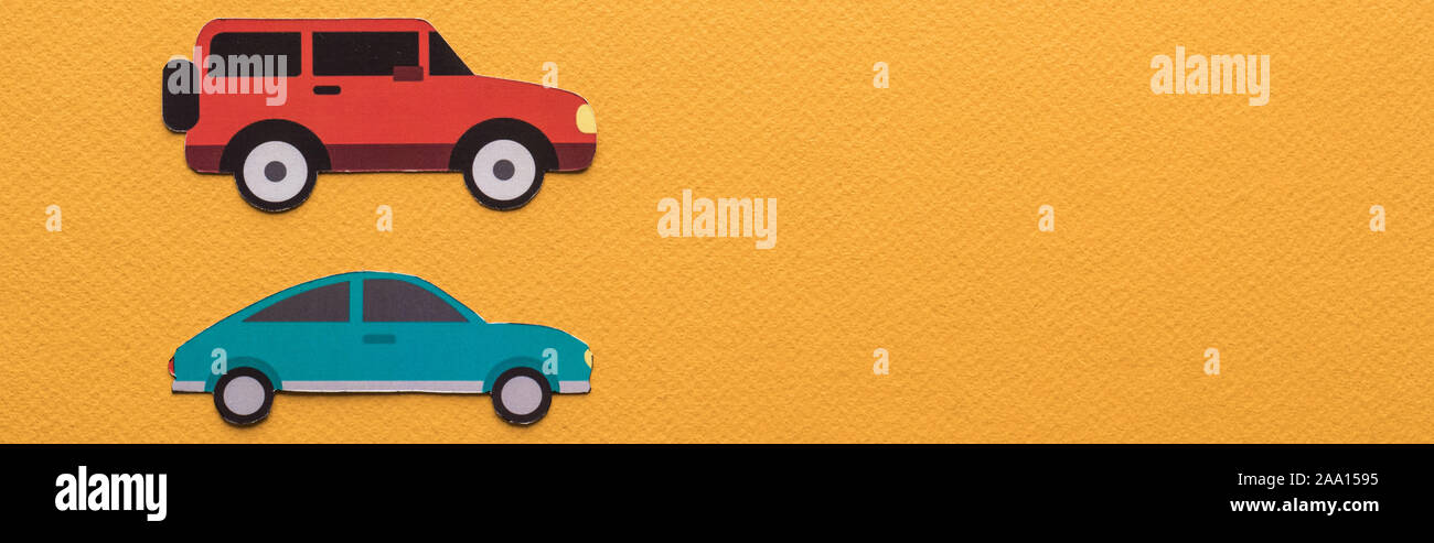 top view of paper cut cars on orange background with copy space ...
