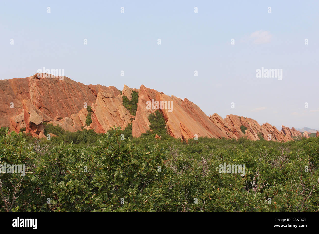 Dramatic red sandstone formations jutting out of the ground, surrounded ...