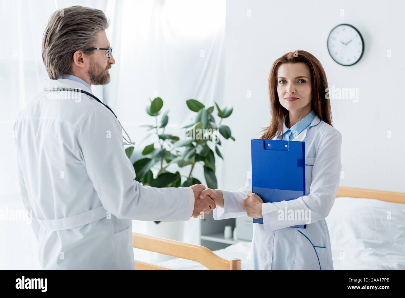 Two young doctors handshake hi-res stock photography and images - Alamy
