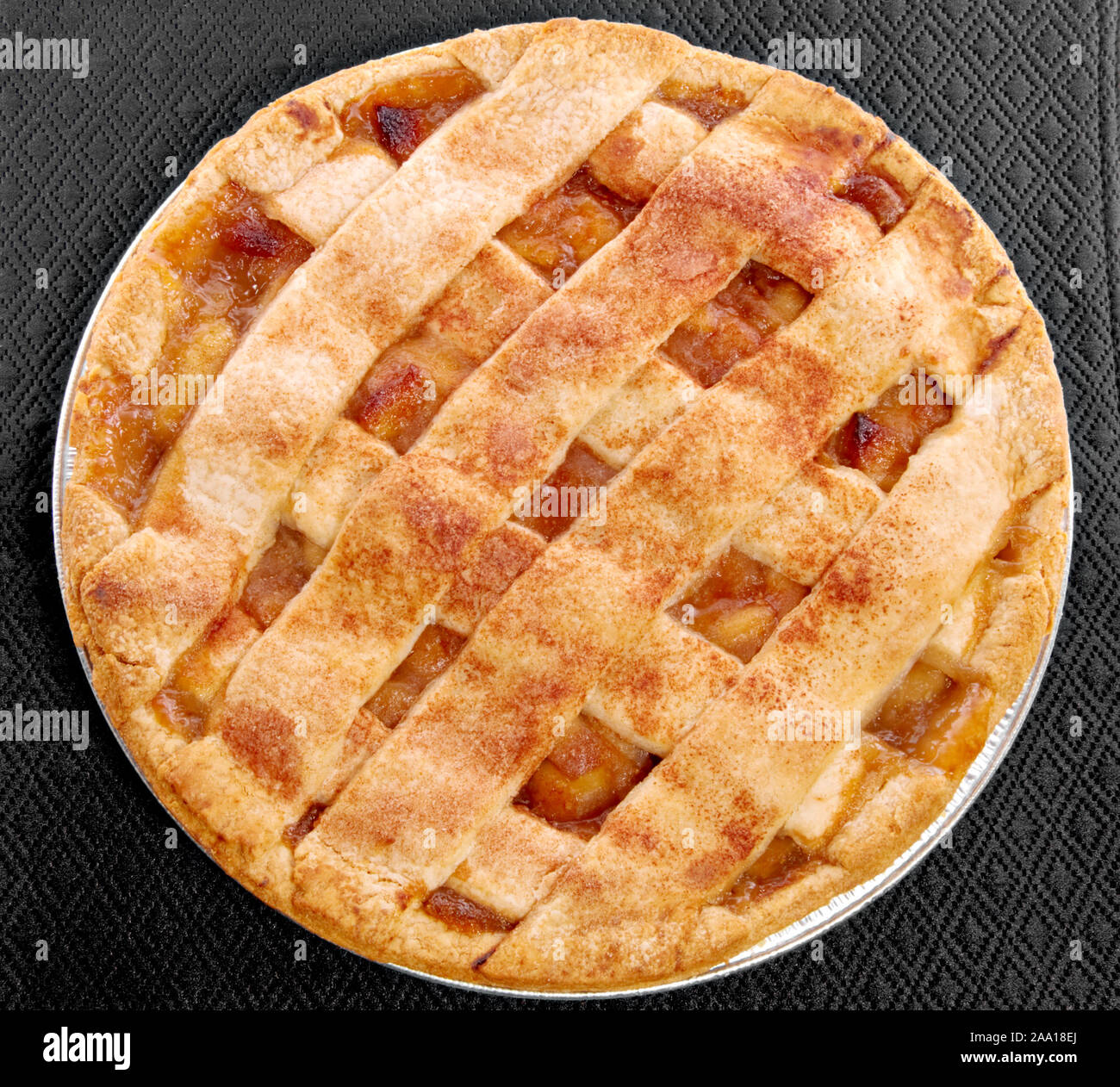 Top view shot of an apple pie with a lattice pastry crust covered with ...