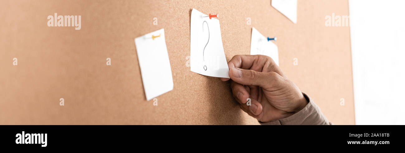 panoramic shot of retired man touching paper with question mark on ...