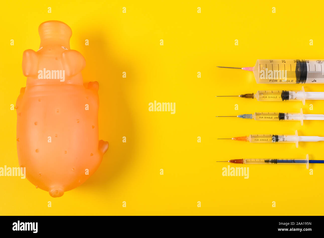 top view syringes with swine on yellow background concept of african ...