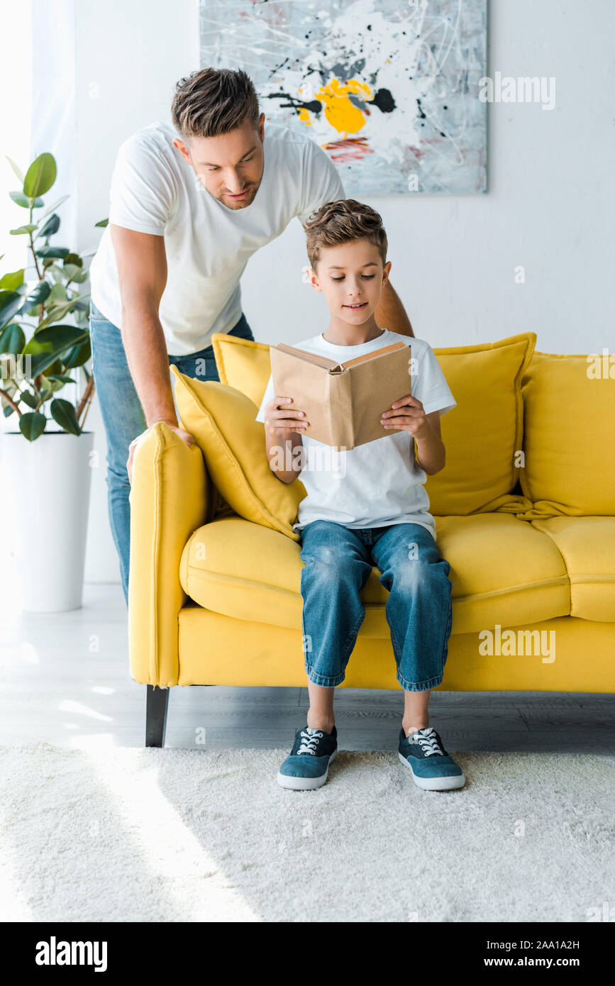 Handsome boy reading book near hi-res stock photography and images - Alamy
