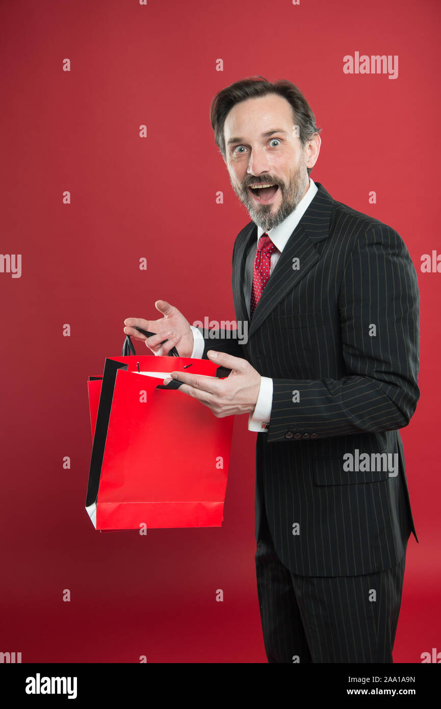 Nice purchase. Shocking discount. Mature businessman hold paper bag ...