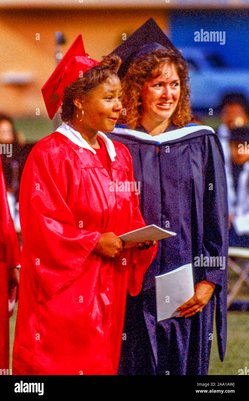 A proud and excited African American high school graduate gets a pat on ...