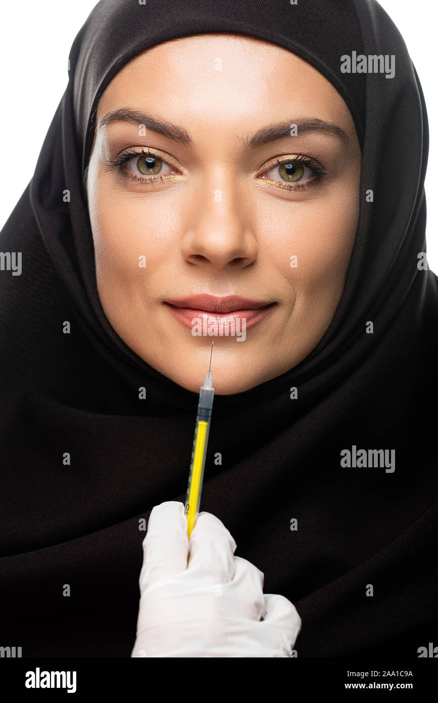 young Muslim woman in hijab having beauty injection isolated on white ...